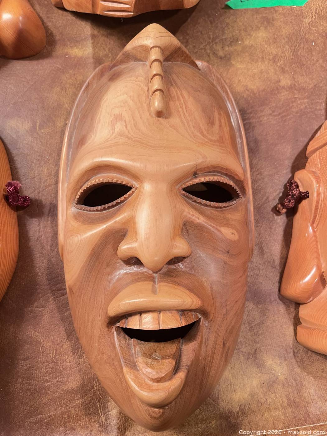 Five carved wood collectible masks | Maxsold