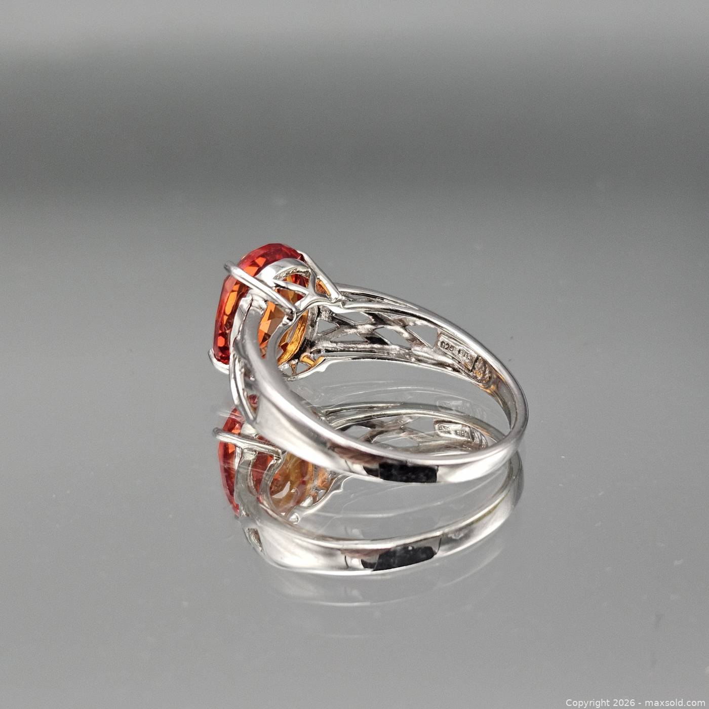 Sterling silver ring with oval orange-red faceted stone | Maxsold