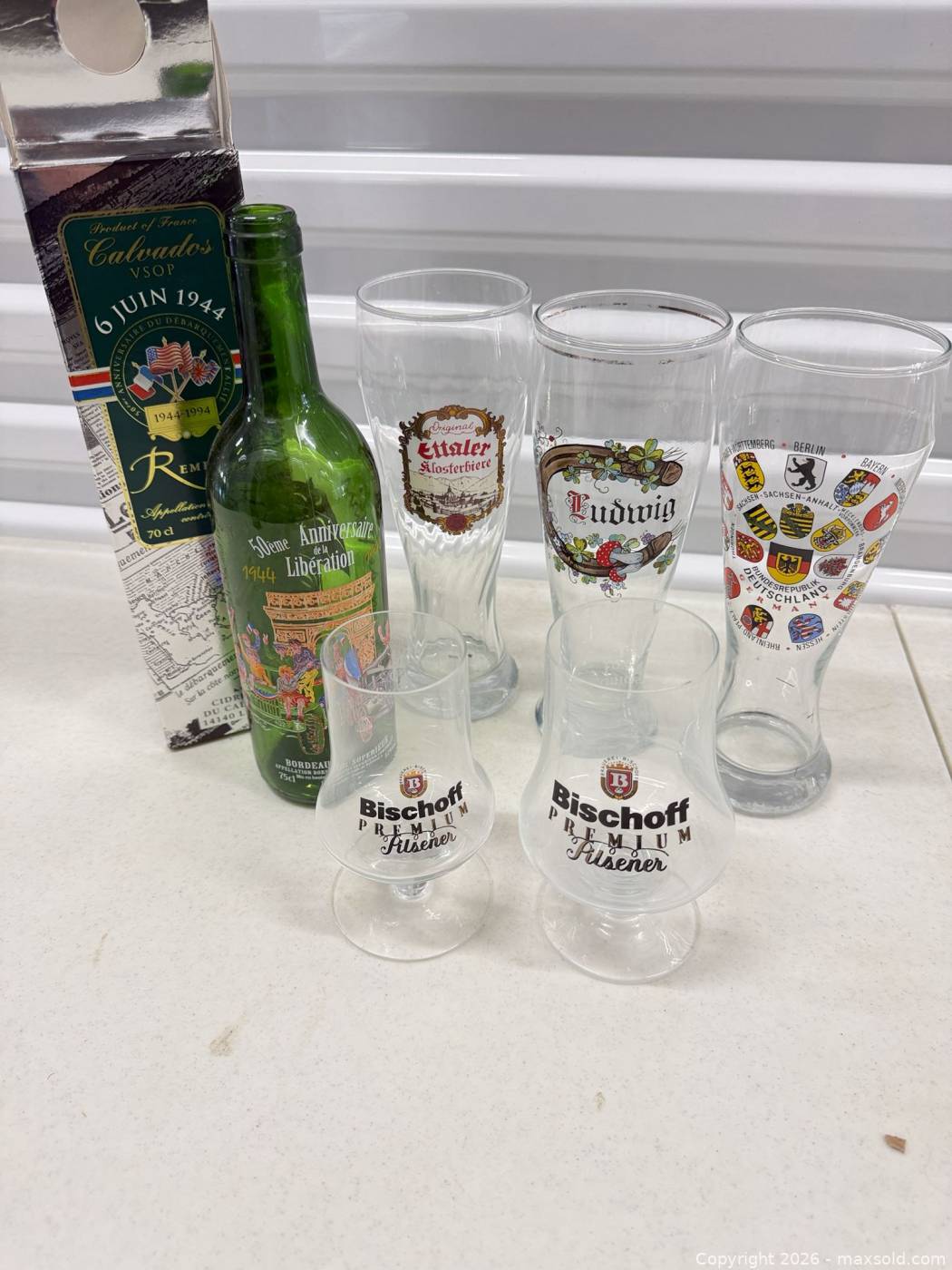Assorted European brewery beer glasses and commemorative wine bottle ...