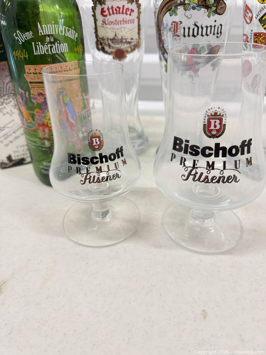 Assorted European brewery beer glasses and commemorative wine bottle ...