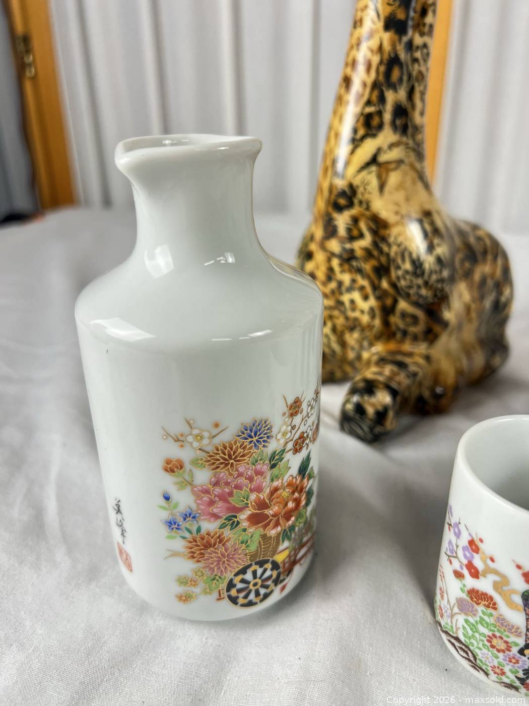 Porcelain sake bottle and cups with carved elephant and ceramic giraffe ...
