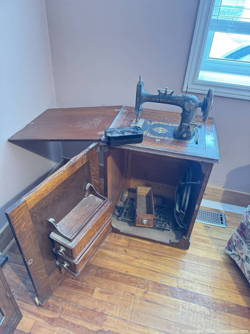 New Williams treadle sewing machine in cabinet with accessories | Maxsold