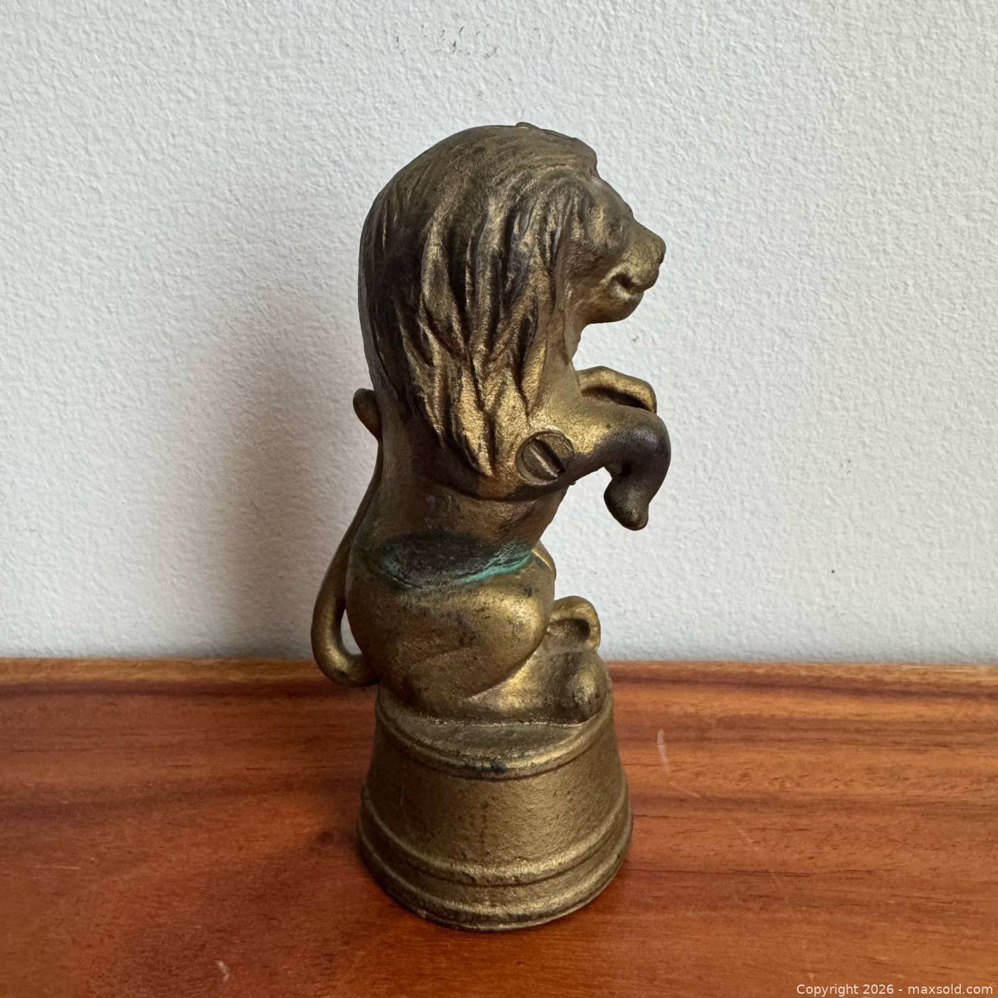 A.C. Williams cast iron lion coin bank | Maxsold