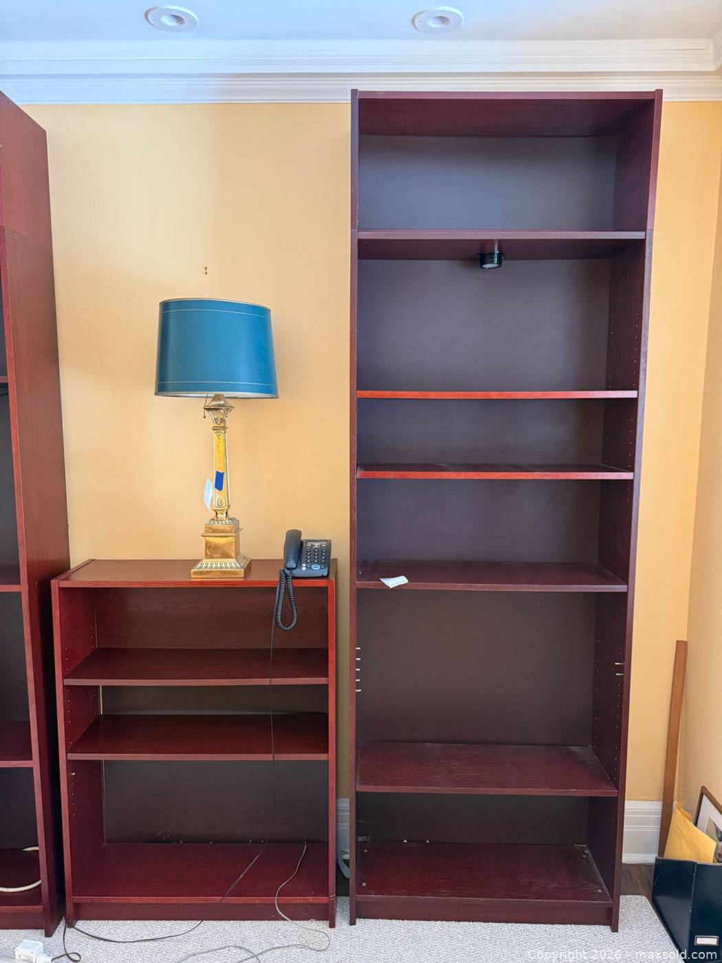 Tall and small red faux oak veneer bookcases | Maxsold