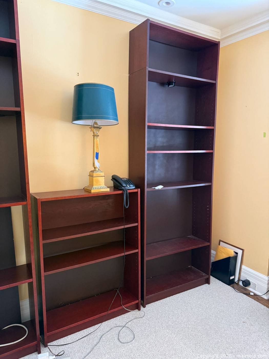 Tall and small red faux oak veneer bookcases | Maxsold