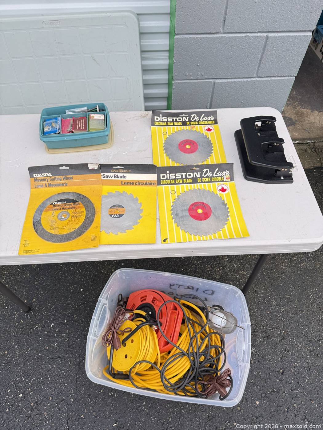 Assorted circular saw and masonry blades with extension cords and work ...