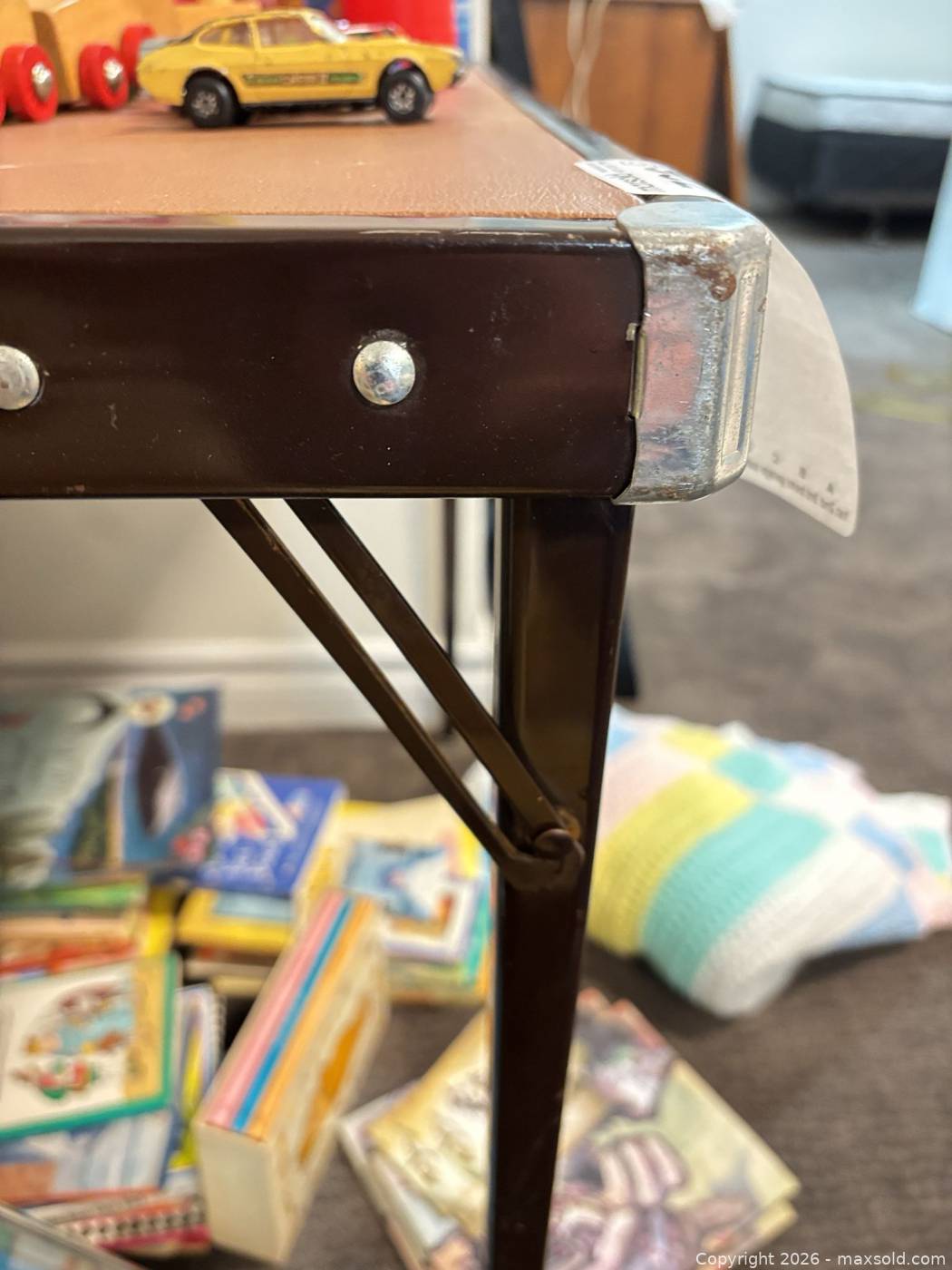 Folding brown metal card table | Maxsold