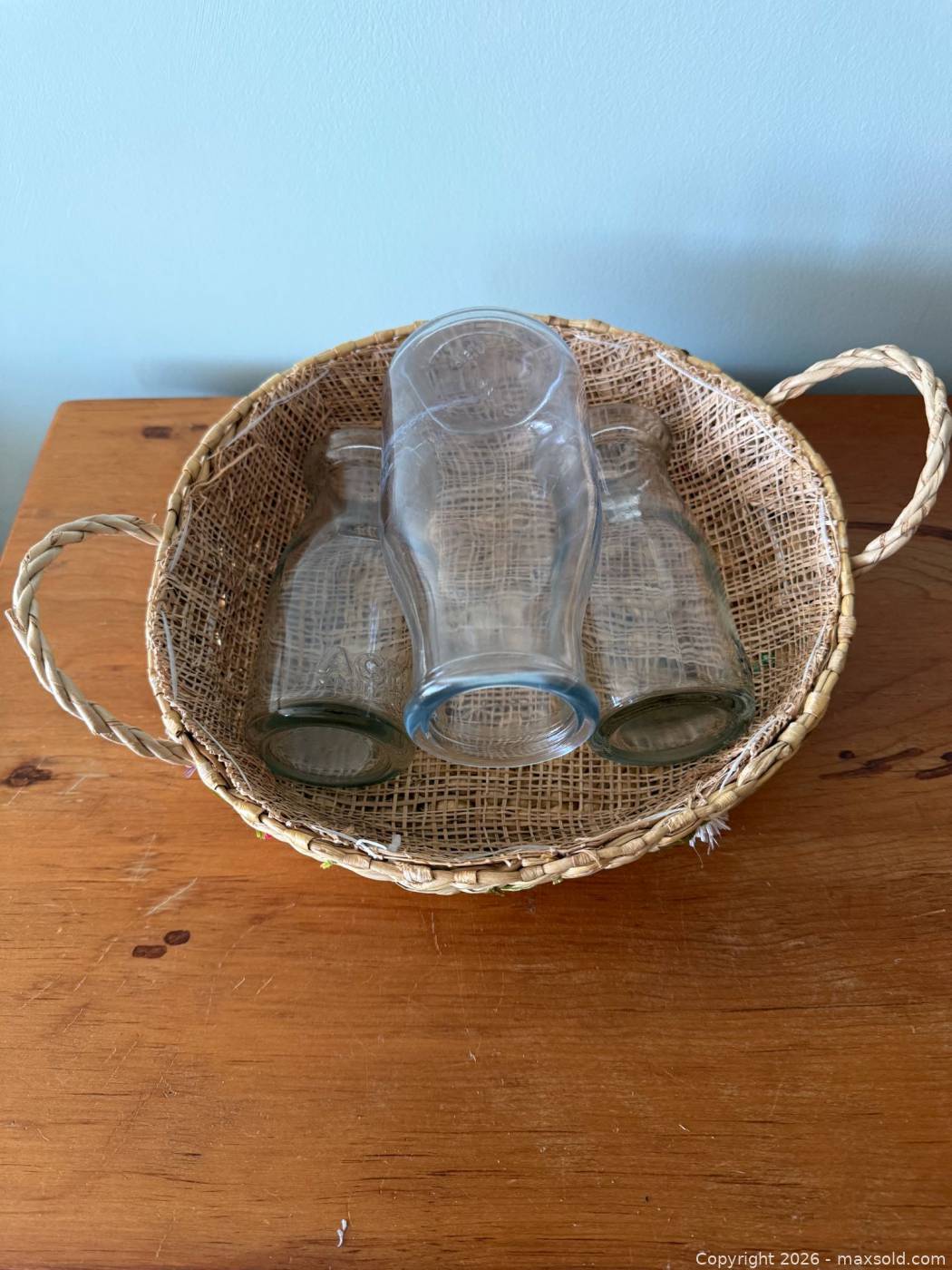 Three glass milk jars with wicker basket | Maxsold