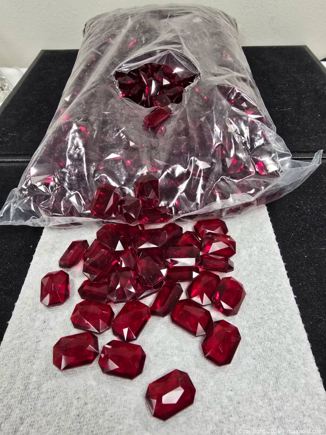 Red acrylic faceted gems bag | Maxsold