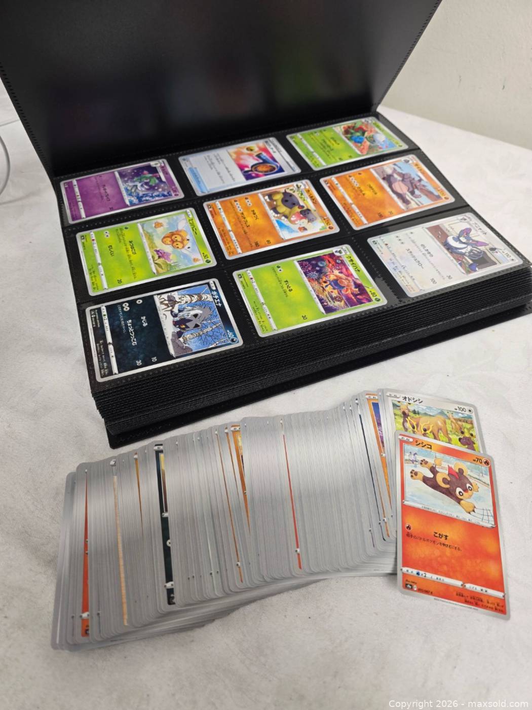 Japanese Pokémon TCG card collection in binder and loose stack | Maxsold