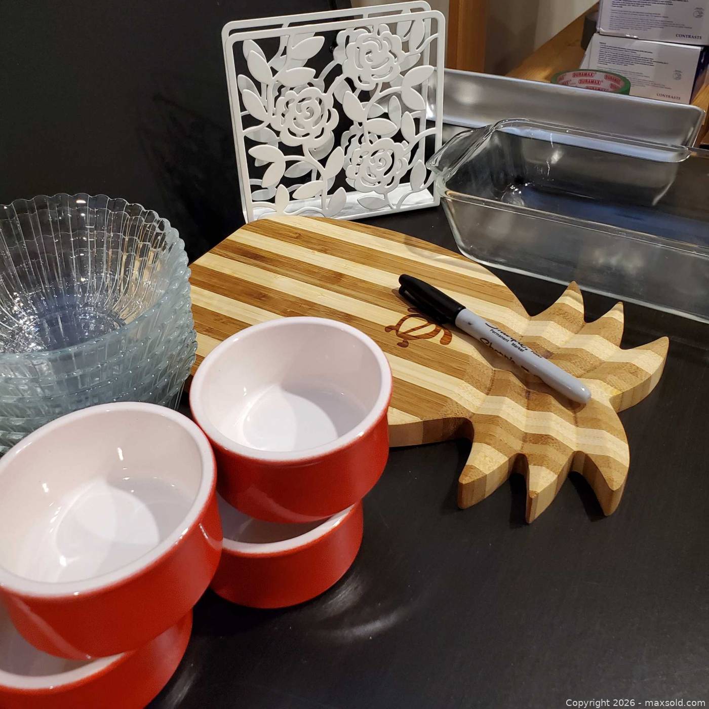 Glass dessert bowls, red ramekins, Pyrex loaf pan, metal ice tray ...