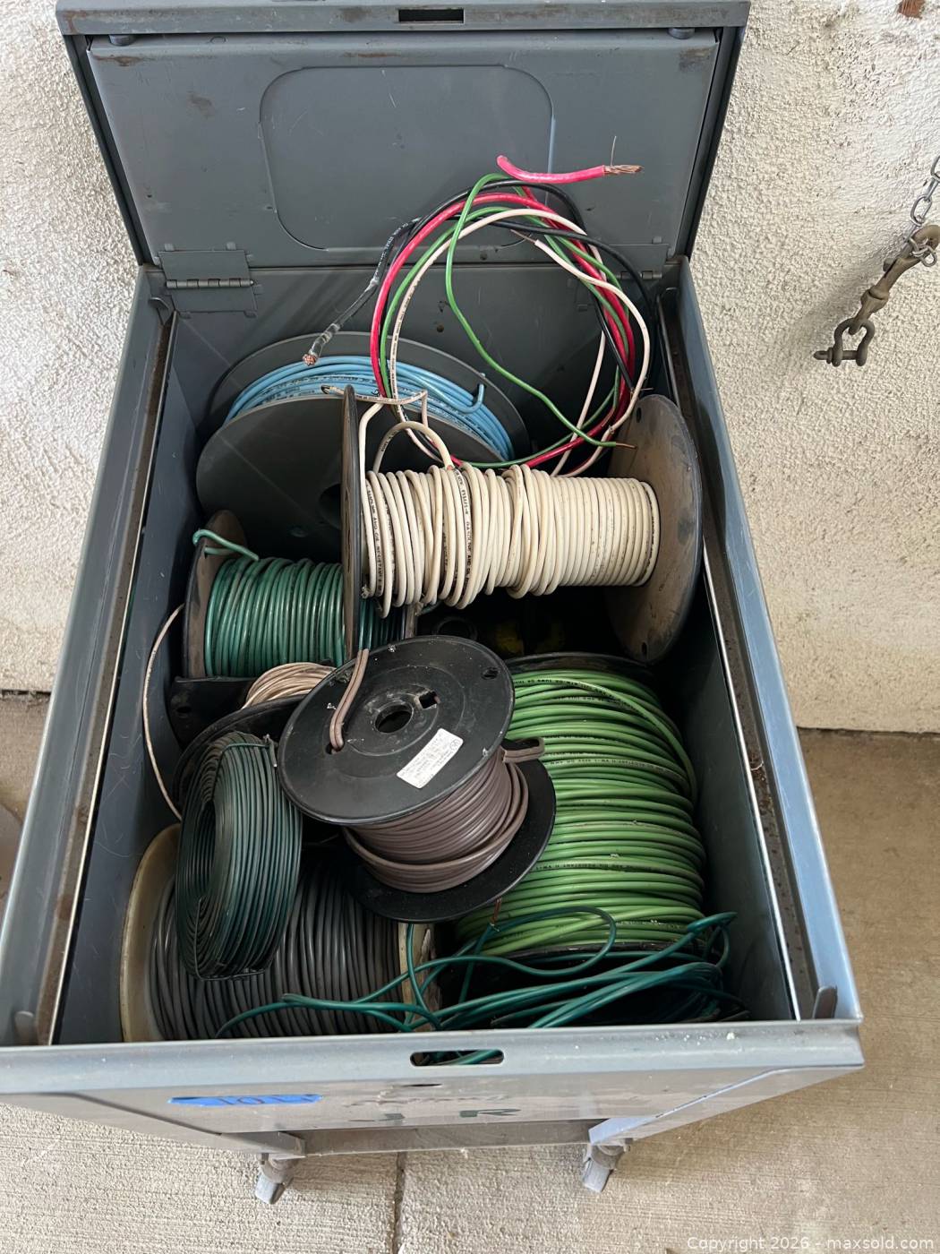 Rolling metal cart with multiple spools of insulated electrical wire ...