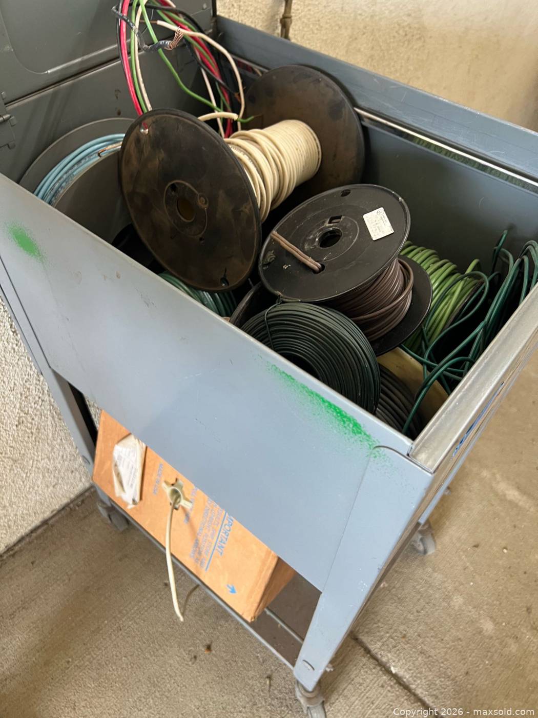 Rolling metal cart with multiple spools of insulated electrical wire ...