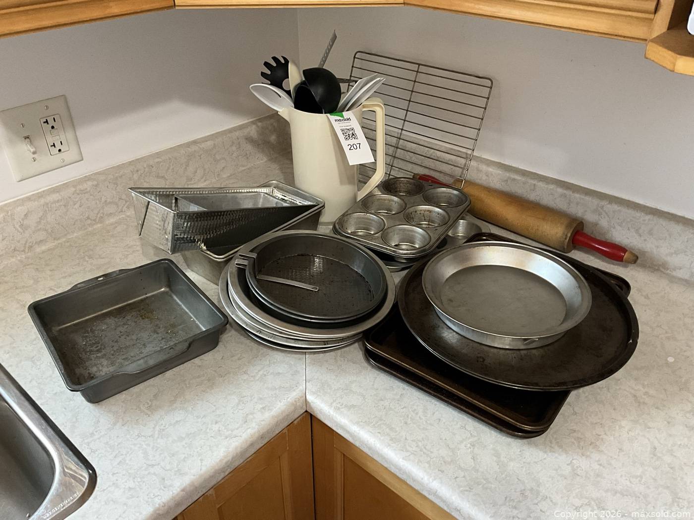 Assorted metal baking pans, sheets, muffin tin, cooling rack, wooden ...