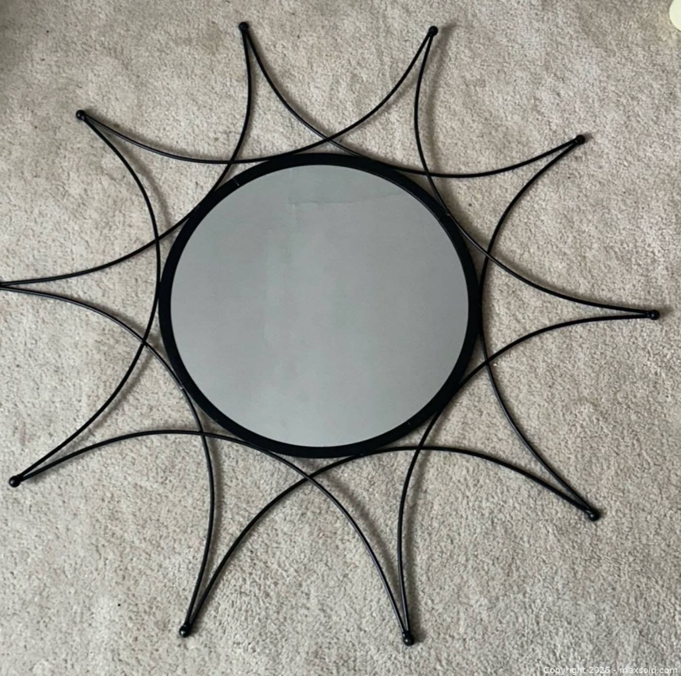 Atomic style black metal round wall mirror | Maxsold