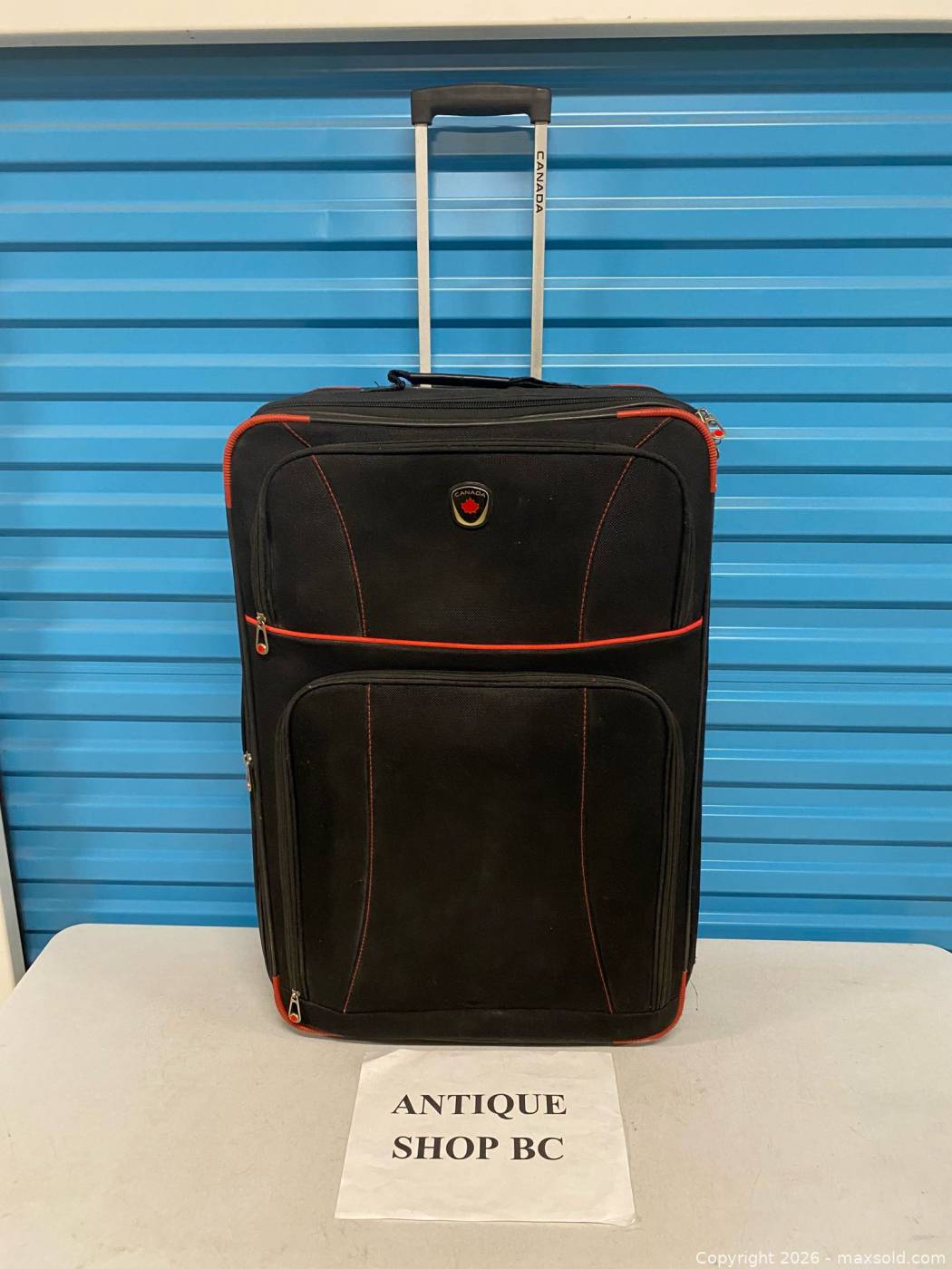 Large black soft-sided rolling suitcase | Maxsold