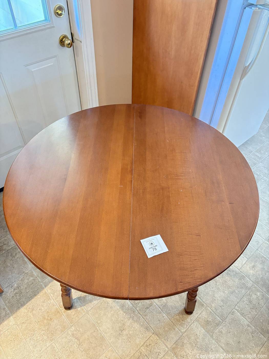 Round solid wood kitchen table with 18-inch leaf | Maxsold