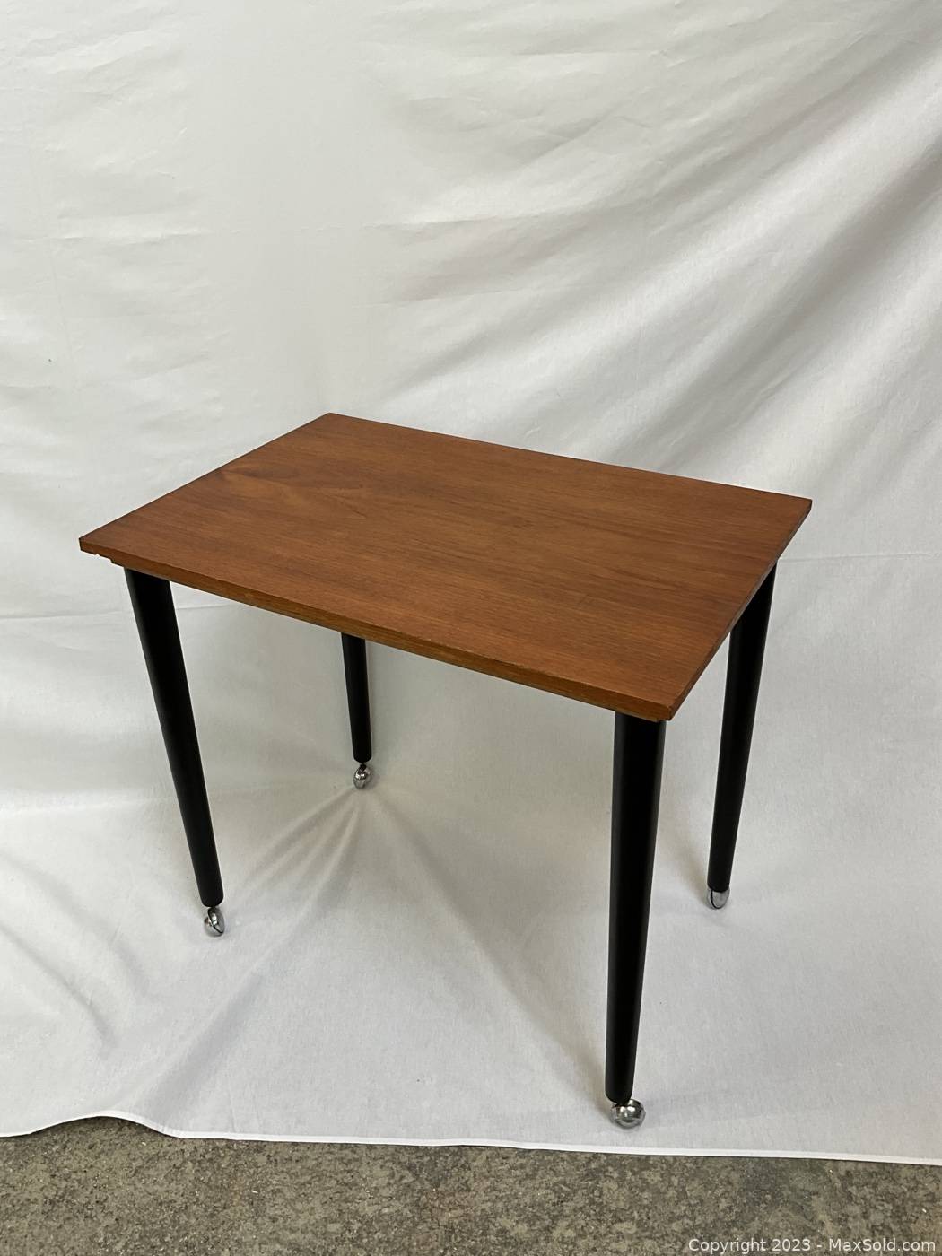Mid-Century Modern Teak Rolling Table with Black Legs | Maxsold