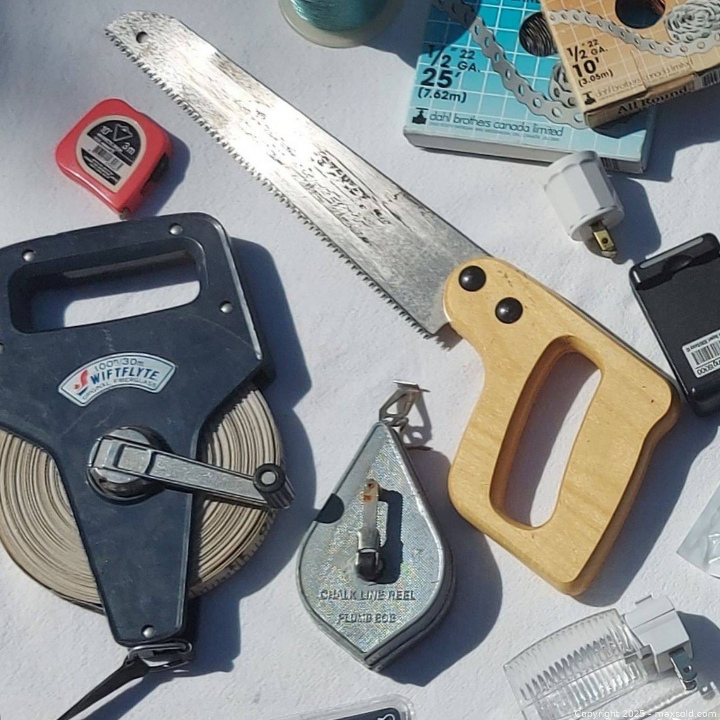 Chalk line, tape reels, hand saw, strapping, bulbs and assorted toolbox ...