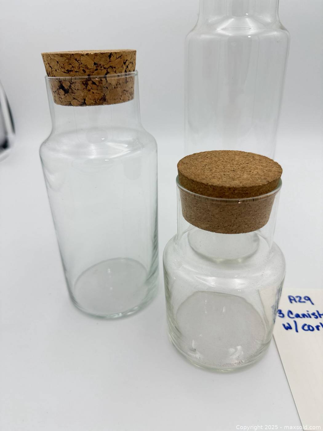 3 glass canisters with cork lids | Maxsold