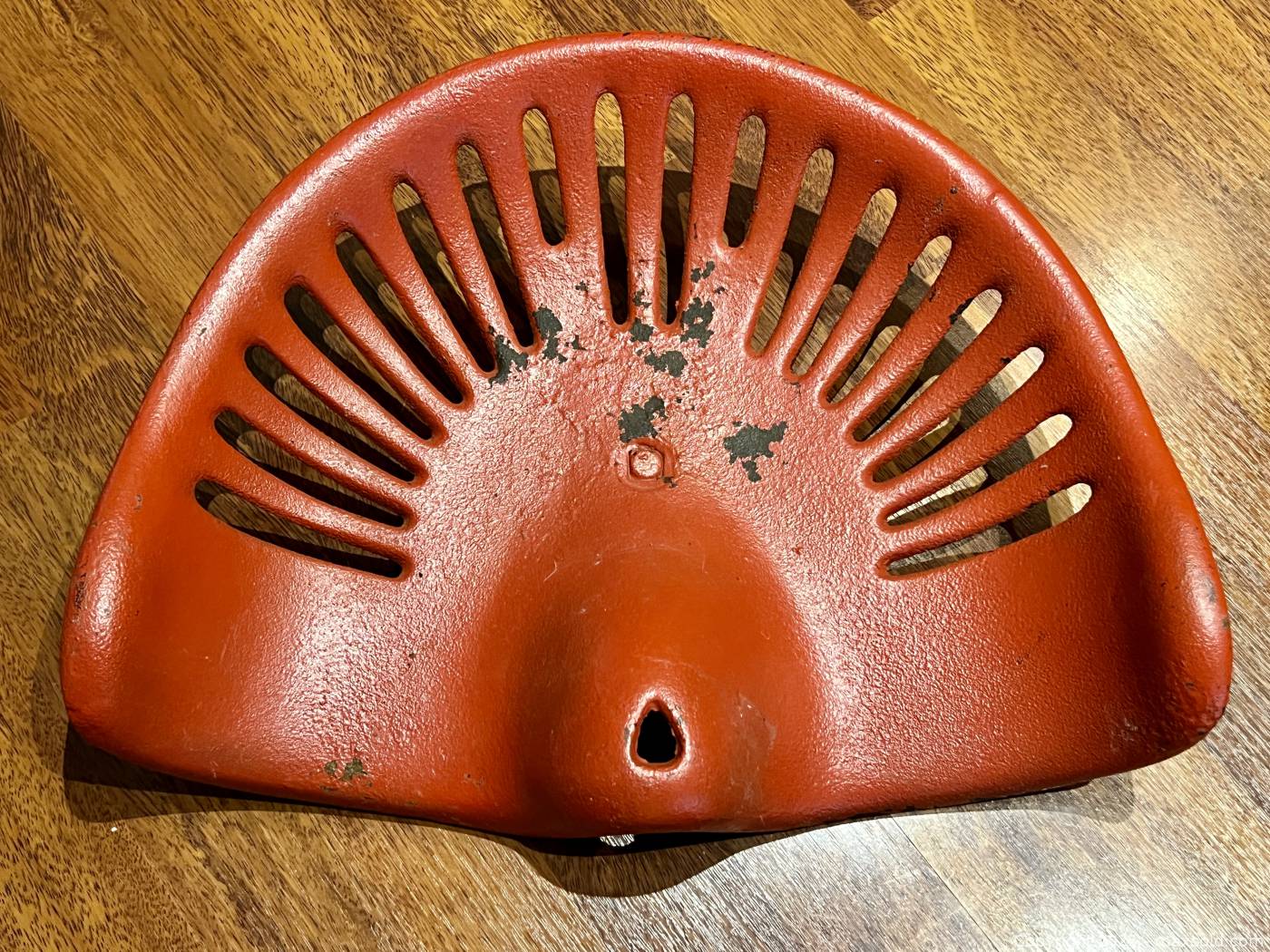 Vintage red cast-iron tractor seat | Maxsold
