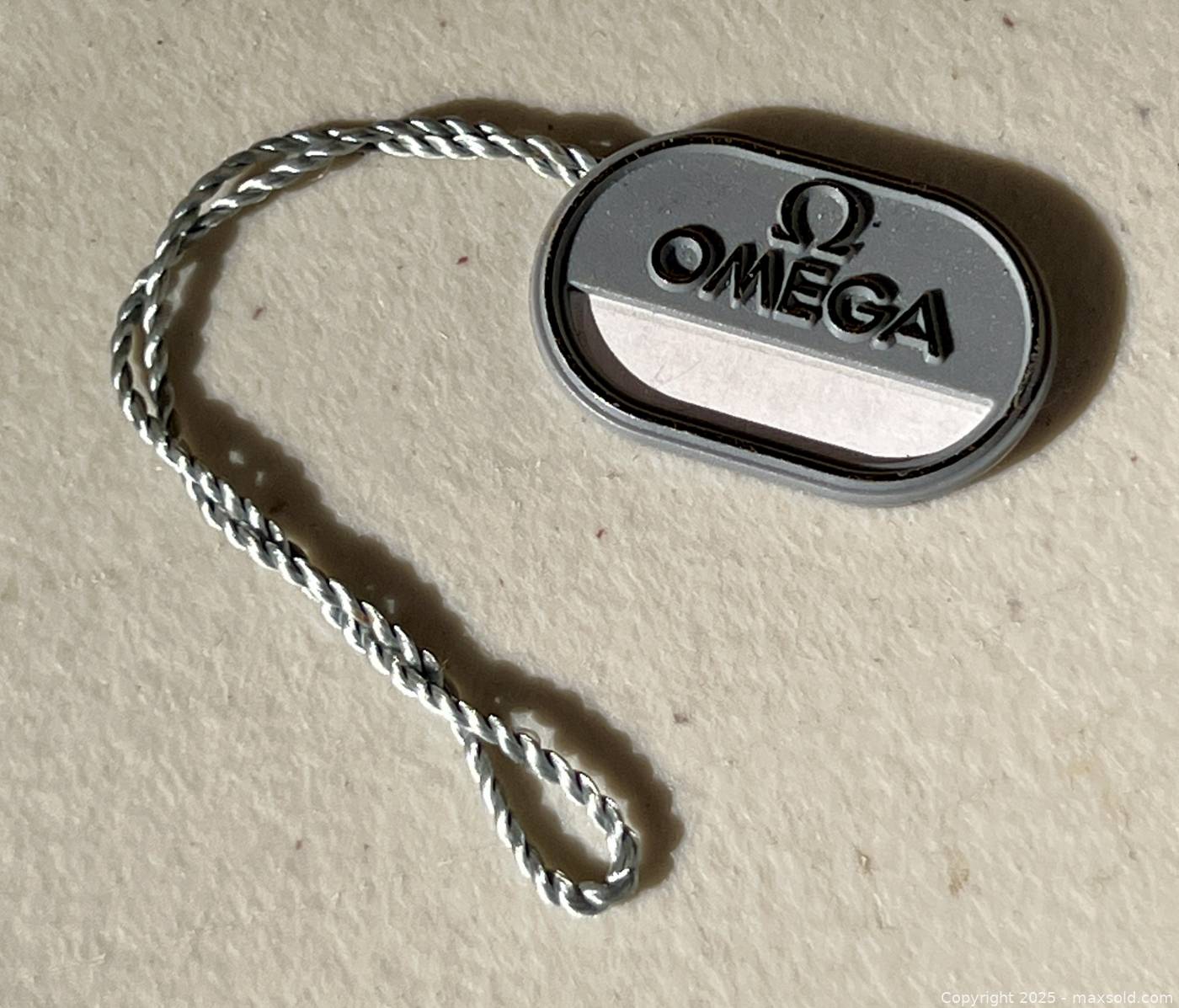 Omega watch reference hang tag | Maxsold