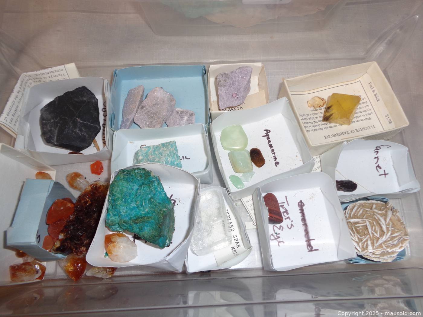 Assorted rocks and mineral specimens in two plastic containers | Maxsold
