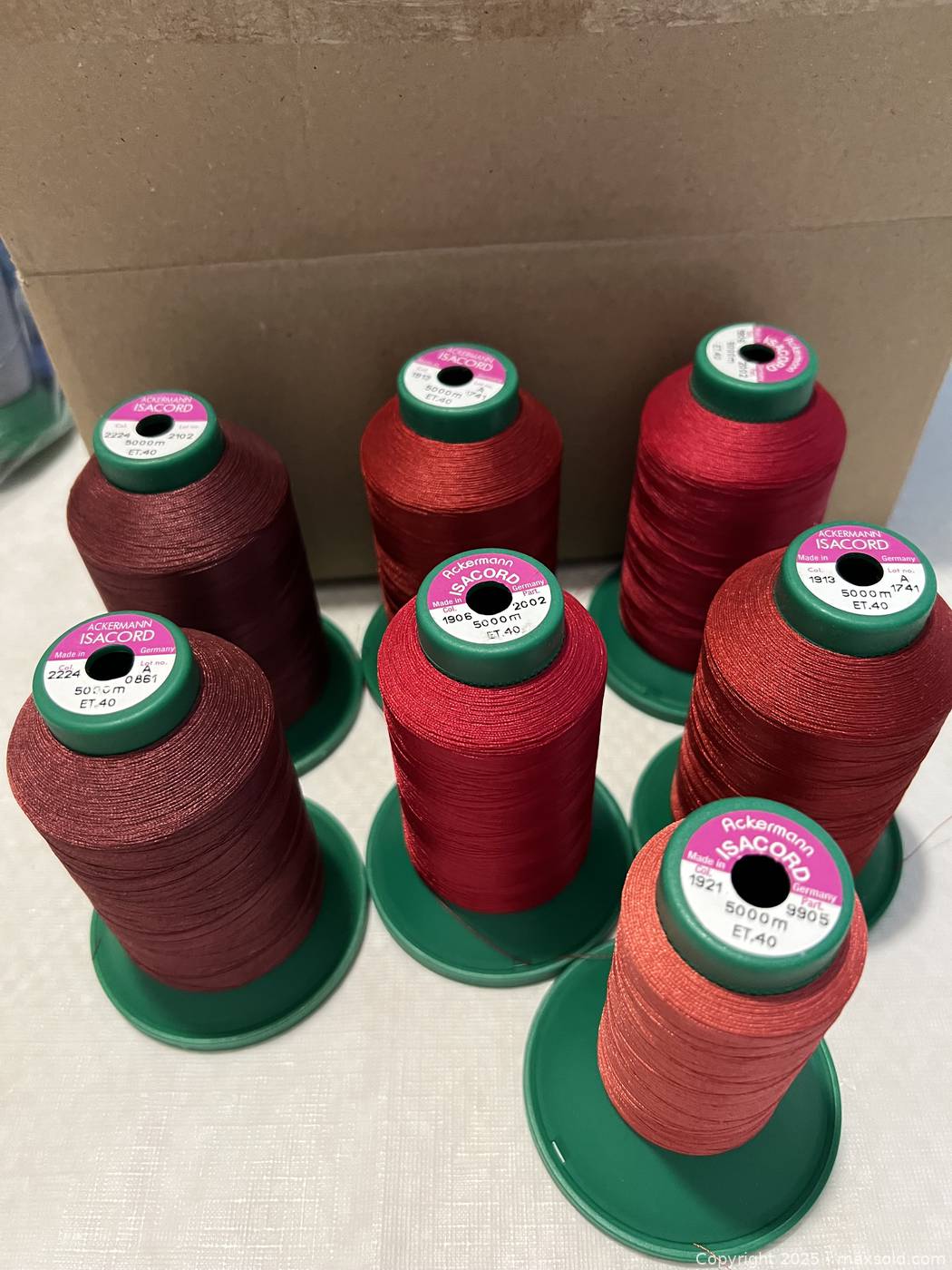 7 large spools red Ackermann Isacord thread | Maxsold
