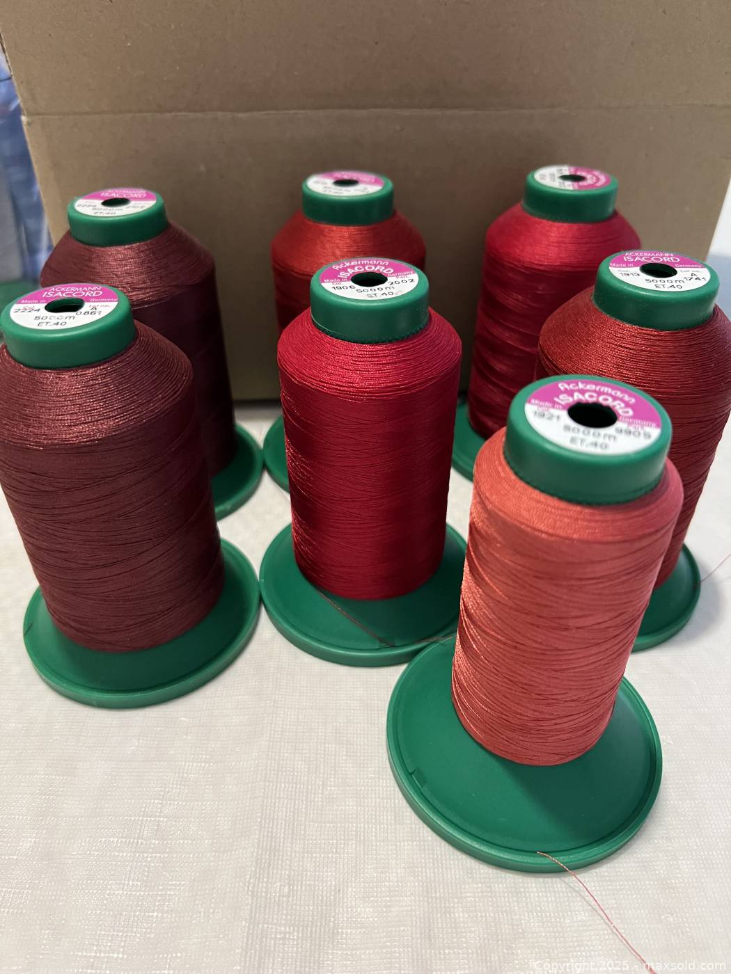 7 large spools red Ackermann Isacord thread | Maxsold