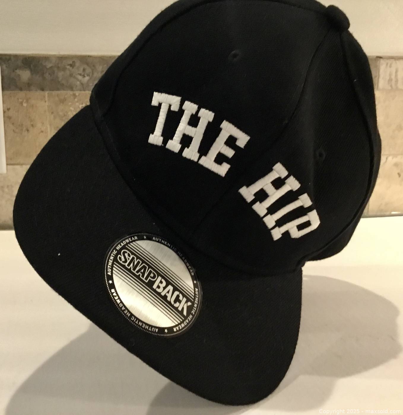Black “THE HIP” snapback baseball cap | Maxsold