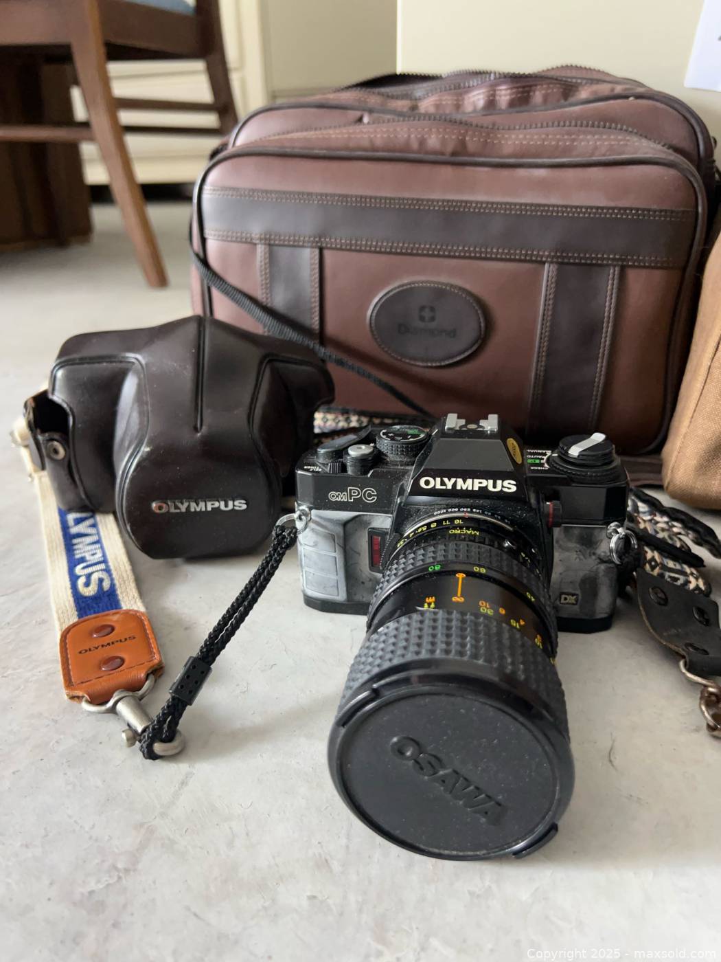 Olympus OM-mount 35mm film SLR set – 2 bodies, 3 lenses, bags | Maxsold