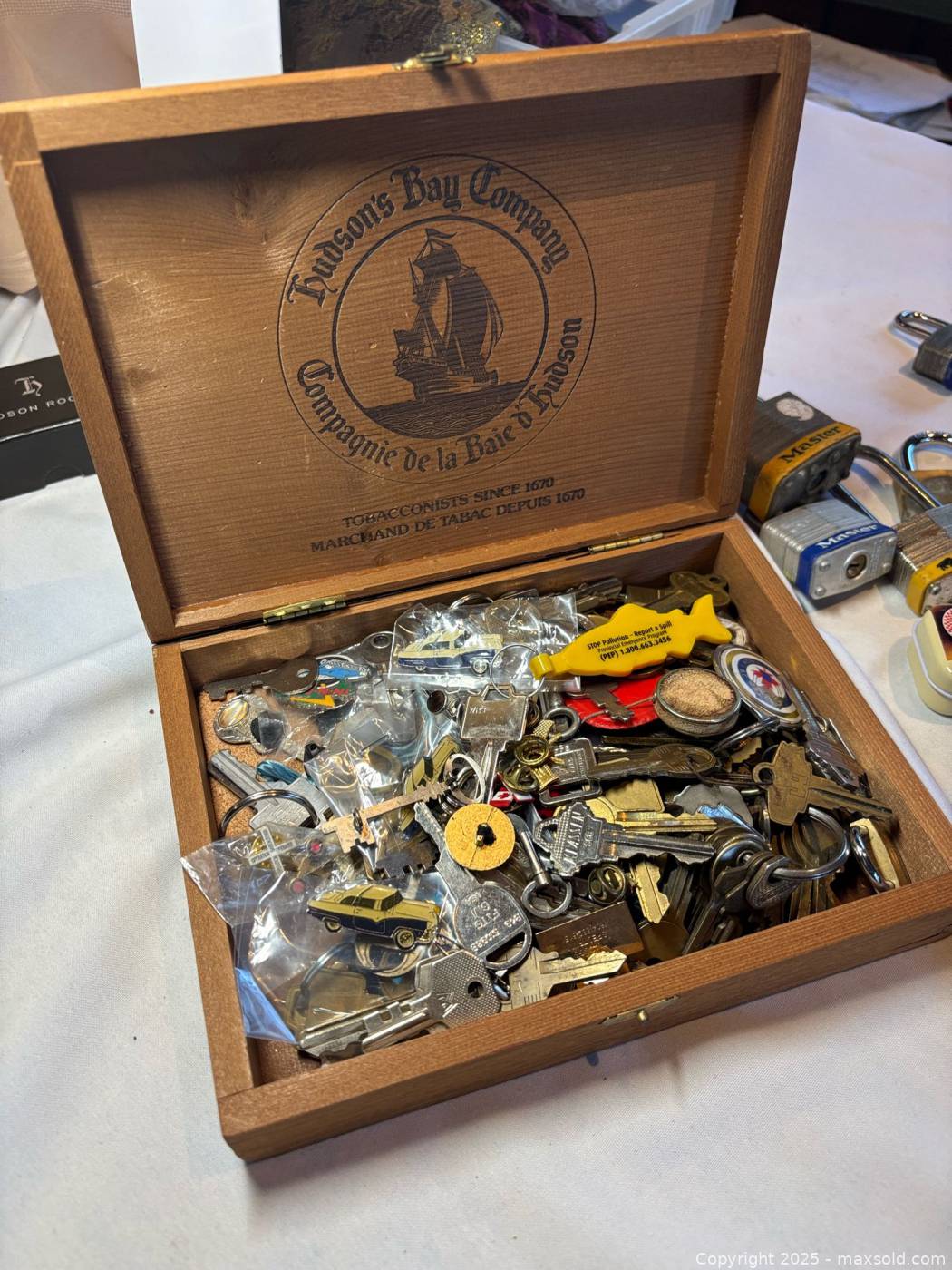 Assorted vintage keys, padlocks, pins, Hudson’s Bay wood box | Maxsold